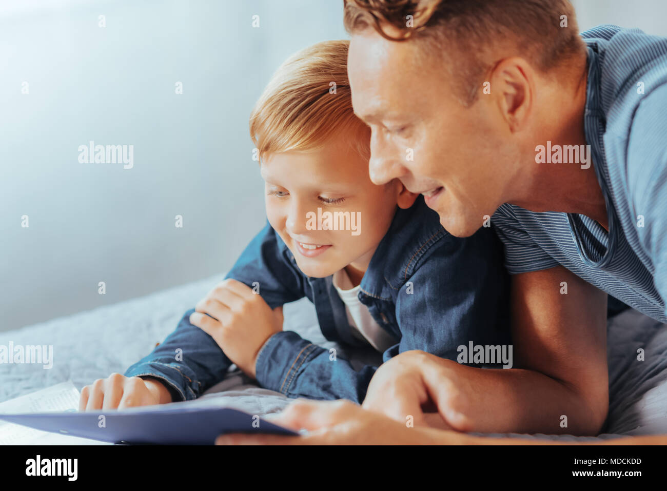 Positive smart man sharing his experience with son Stock Photo - Alamy