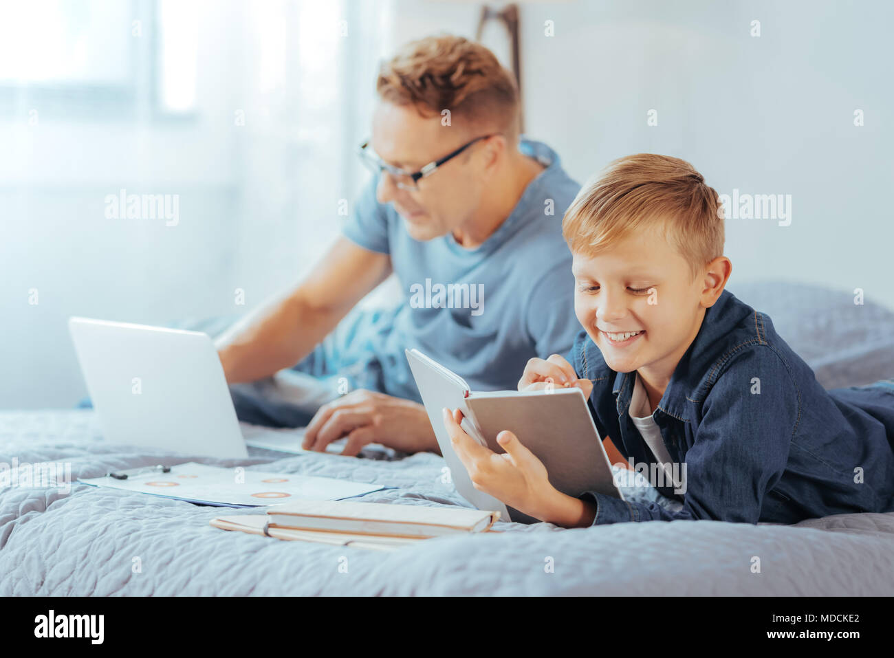 Delighted positive boy taking notes Stock Photo - Alamy