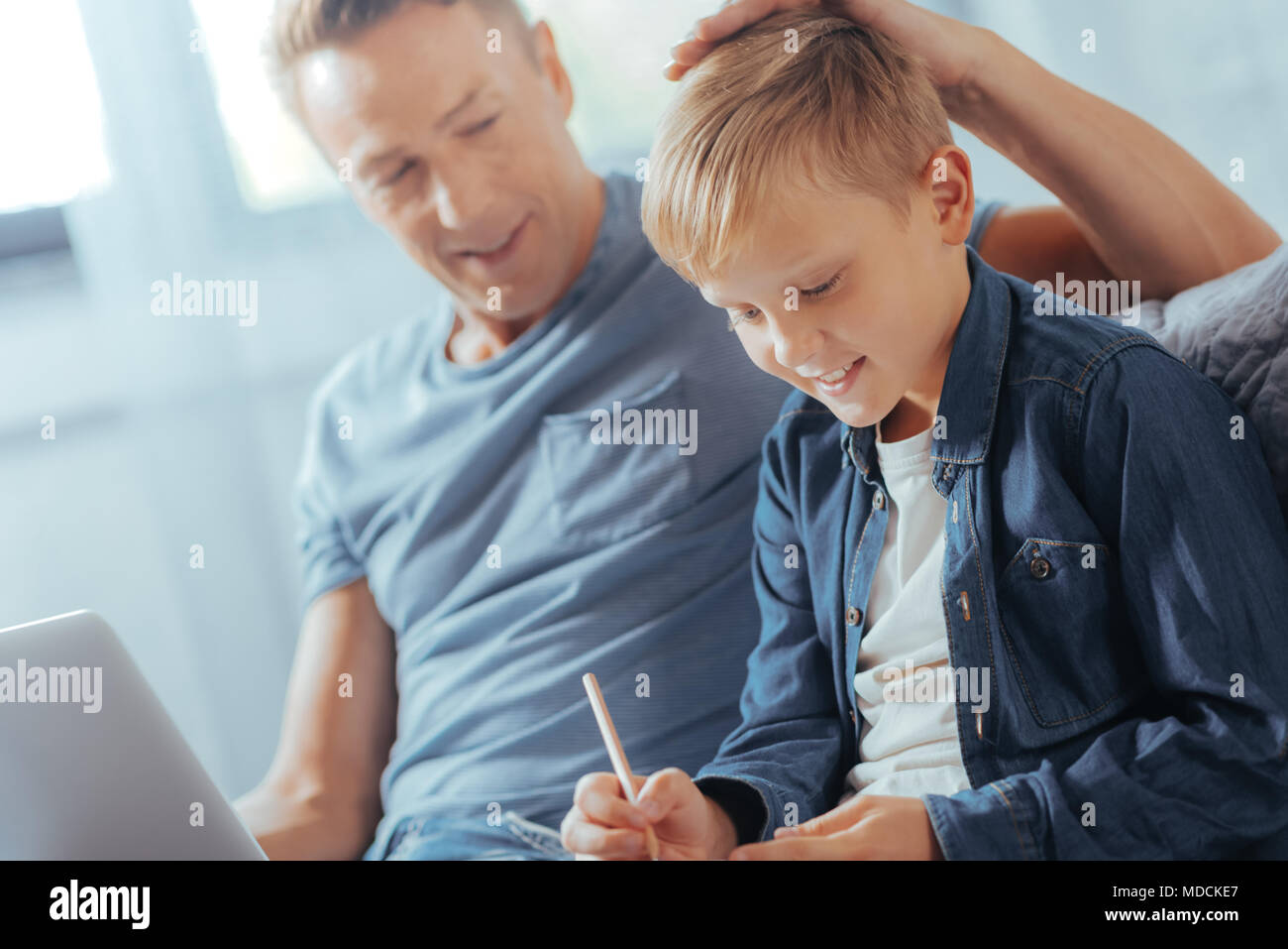 Joyful smart boy studying Stock Photo - Alamy