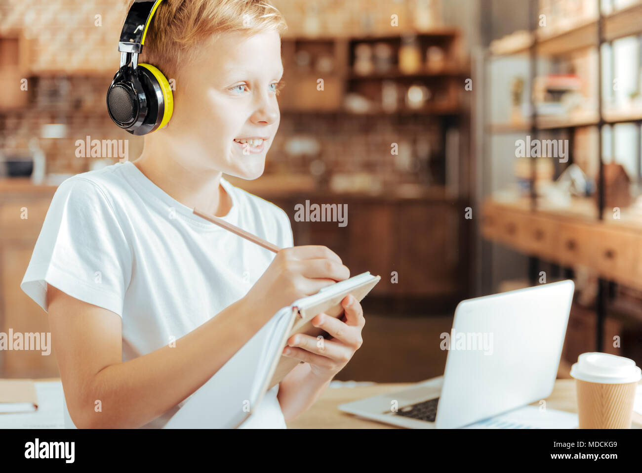 Joyful happy boy taking notes Stock Photo - Alamy
