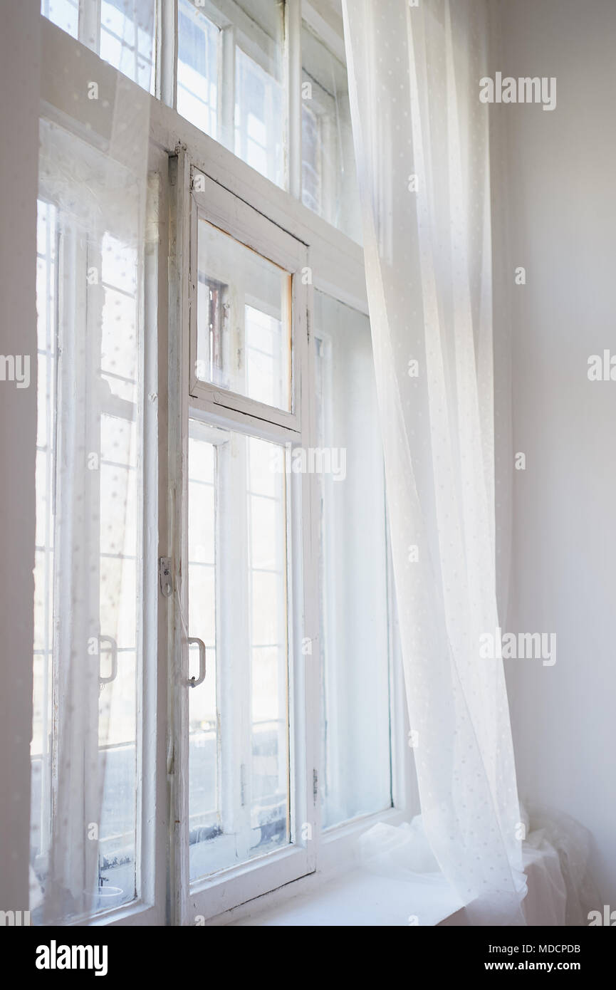 White painted window with old wooden frame.The interior of the ...