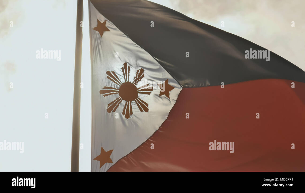 Flying bicolor flag of the Philippines with central golden sun ...