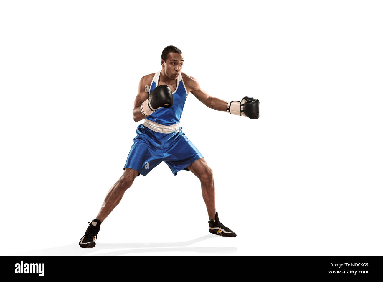 Sporty man during boxing exercise making hit. Photo of boxer on white ...