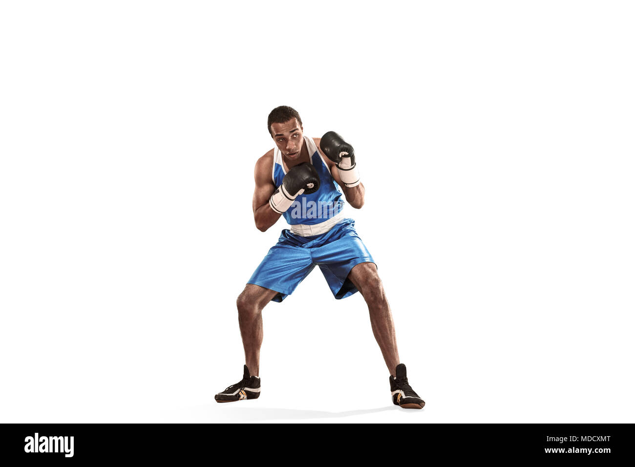Sporty man during boxing exercise making hit. Photo of boxer on white ...