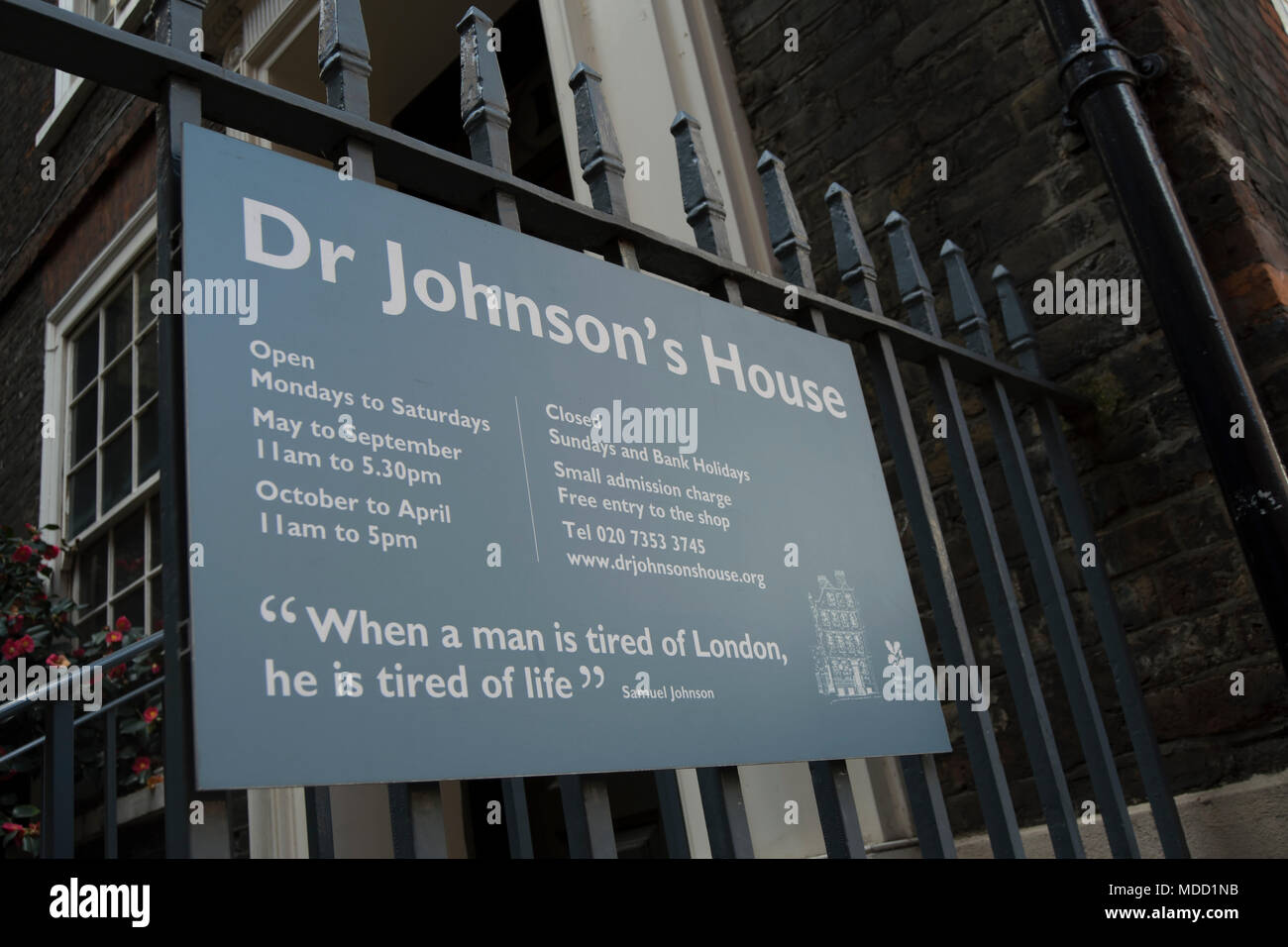 information board with opening times and famous quote at the entrance ...