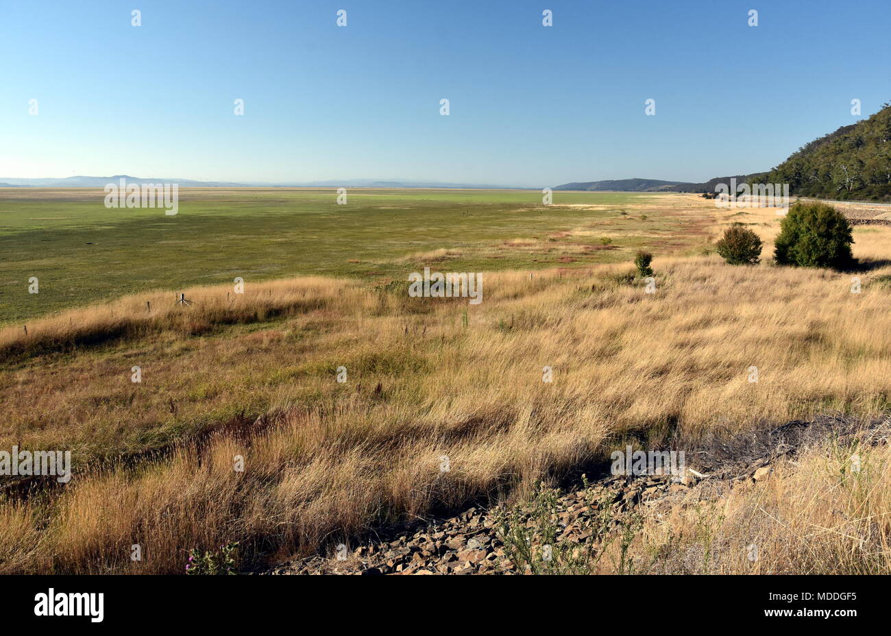 Empty Lake George nestled between a rural wind farm and farmland in ...