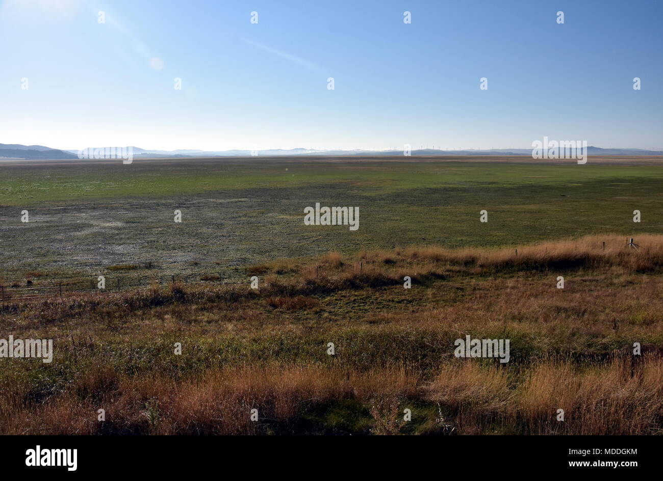 Empty Lake George nestled between a rural wind farm and farmland in ...