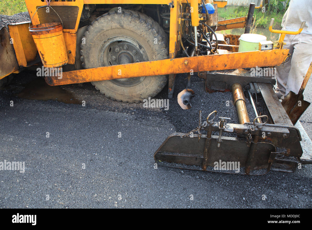 heavy machine working on asphalt Stock Photo - Alamy