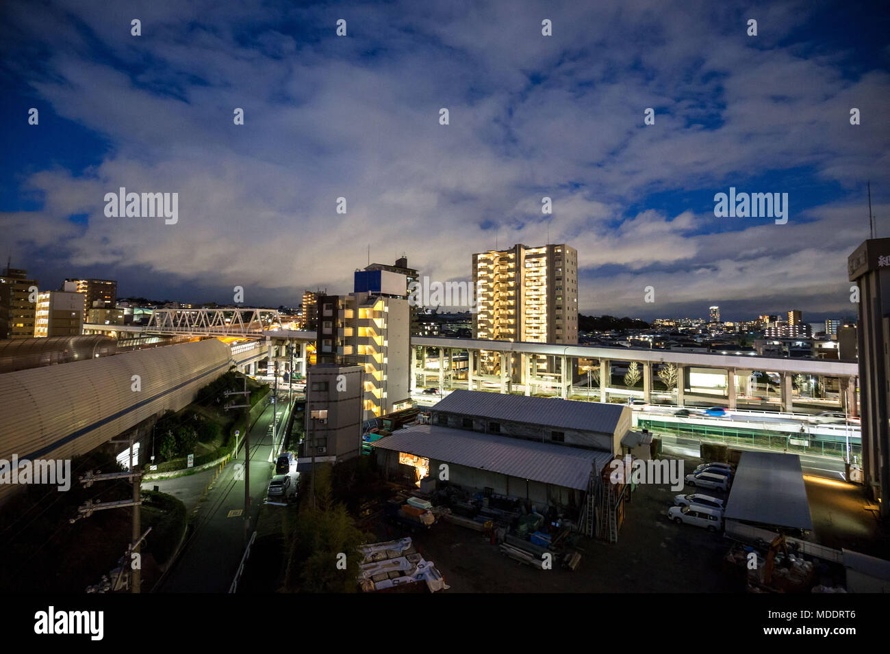 Elevated train bridge crosses urban freeway in northern Osaka, Japan ...