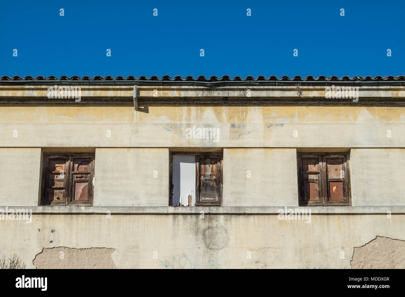three old windows on the outside of a chipped wall Stock Photo - Alamy