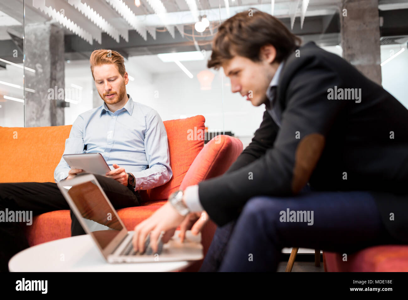 Business people looking at their devices Stock Photo - Alamy