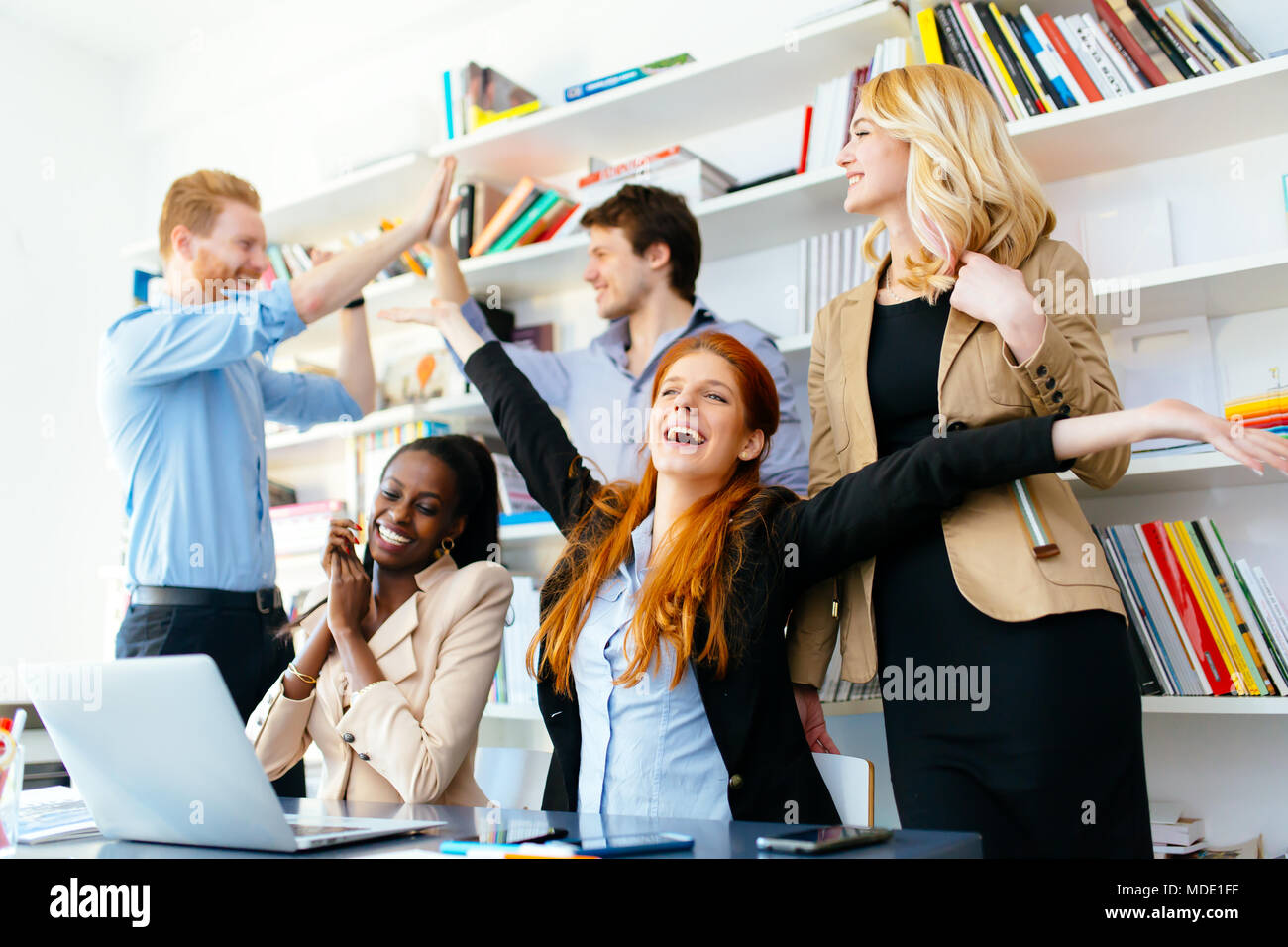 Happy business coworkers celebrating Stock Photo - Alamy