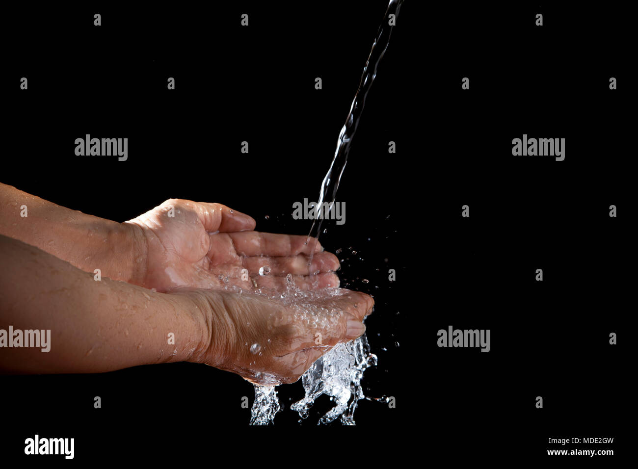file of hand and pouring water on black background Stock Photo - Alamy