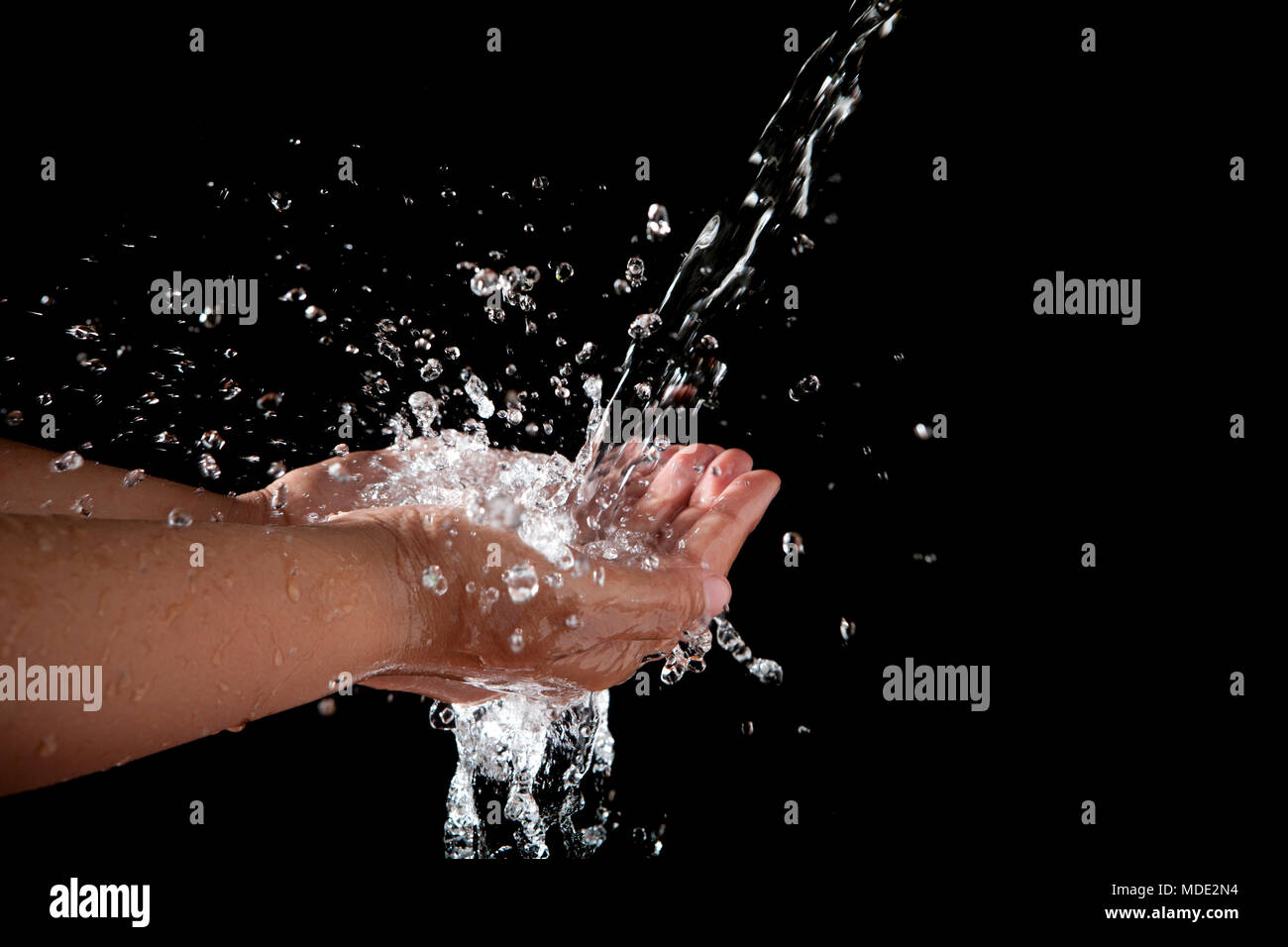 file of hand and pouring water on black background Stock Photo - Alamy