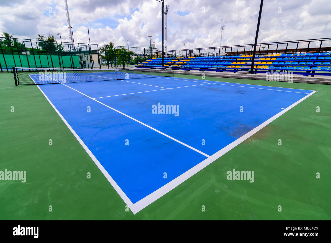 Blue tennis court with lines. Clouds blue sky background Stock Photo ...