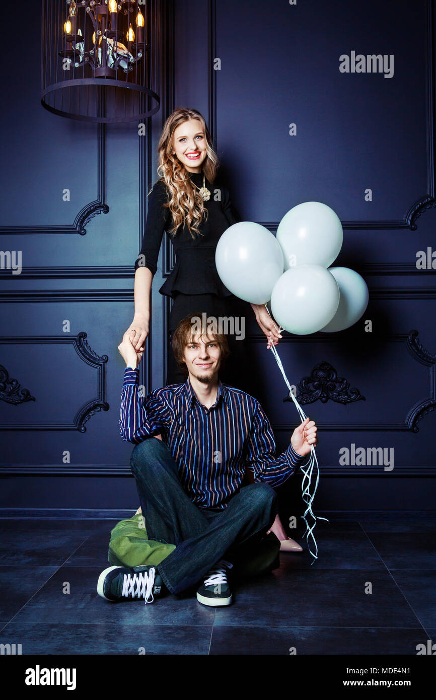 happy beautiful young couple against studio background with white ...