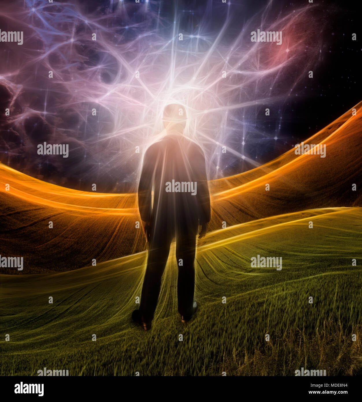 Explosion of imagination. Man stands in green field Stock Photo - Alamy