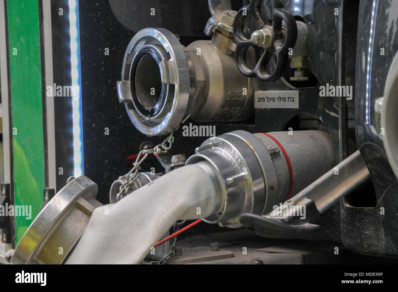 Firemen connect a fire house to a pump Stock Photo - Alamy
