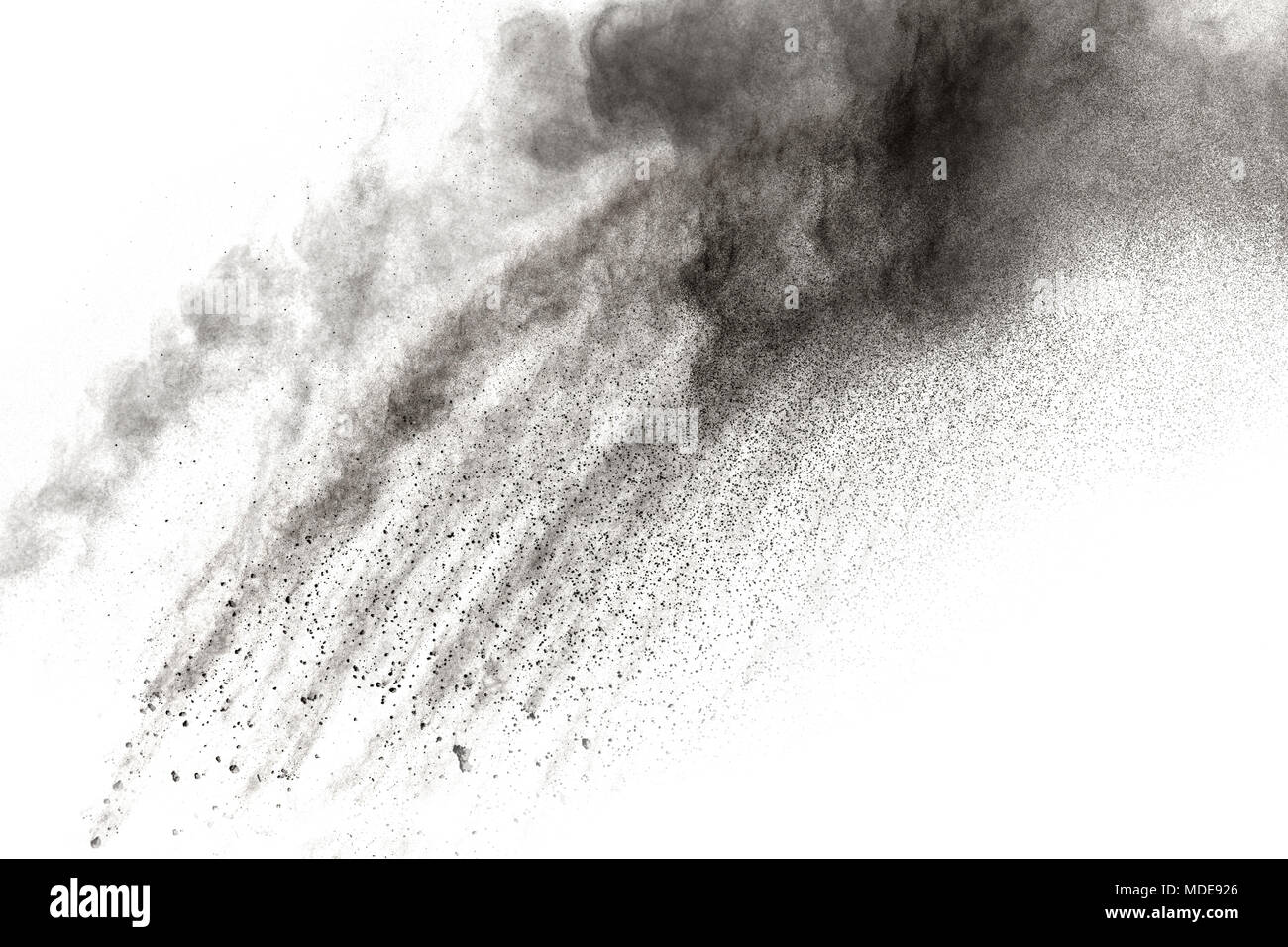 Black powder explosion against white background.The particles of ...