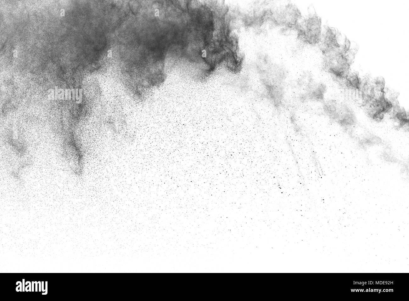 Black powder explosion against white background.The particles of ...