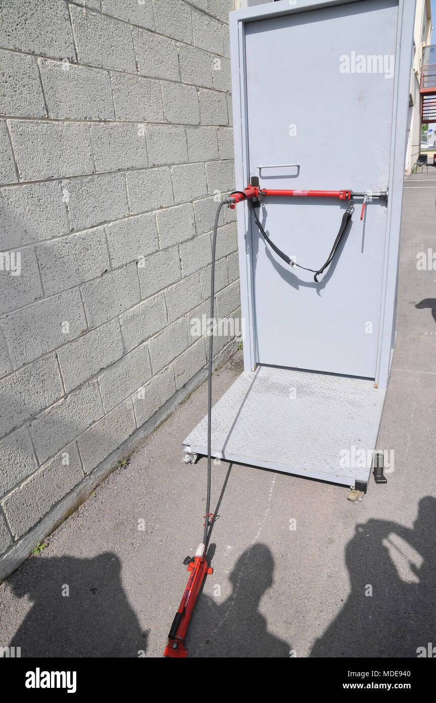 Fire fighter uses hydraulic tools to breach a locked door Stock Photo ...