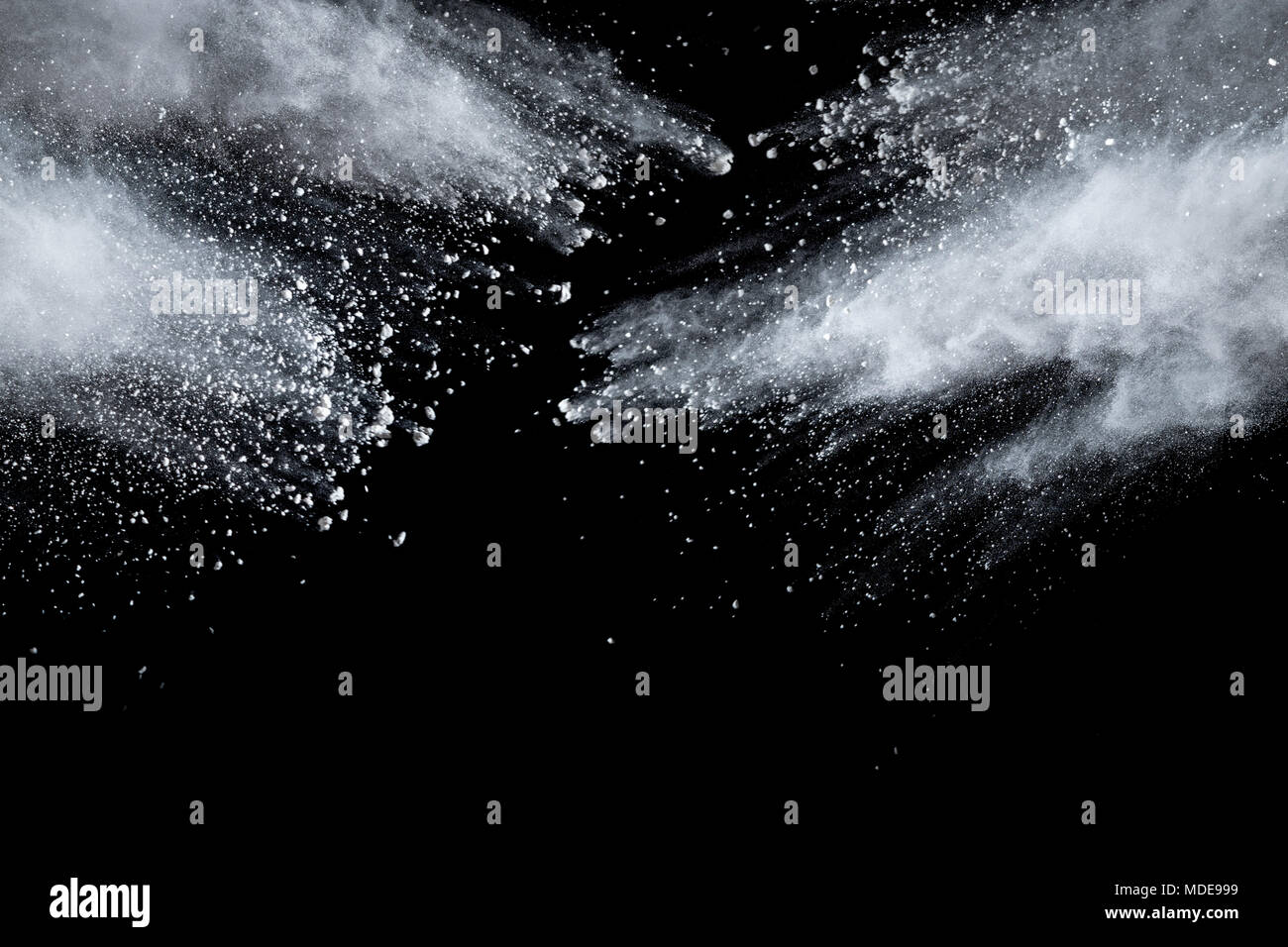 Bizarre forms of white powder explosion cloud against dark background ...