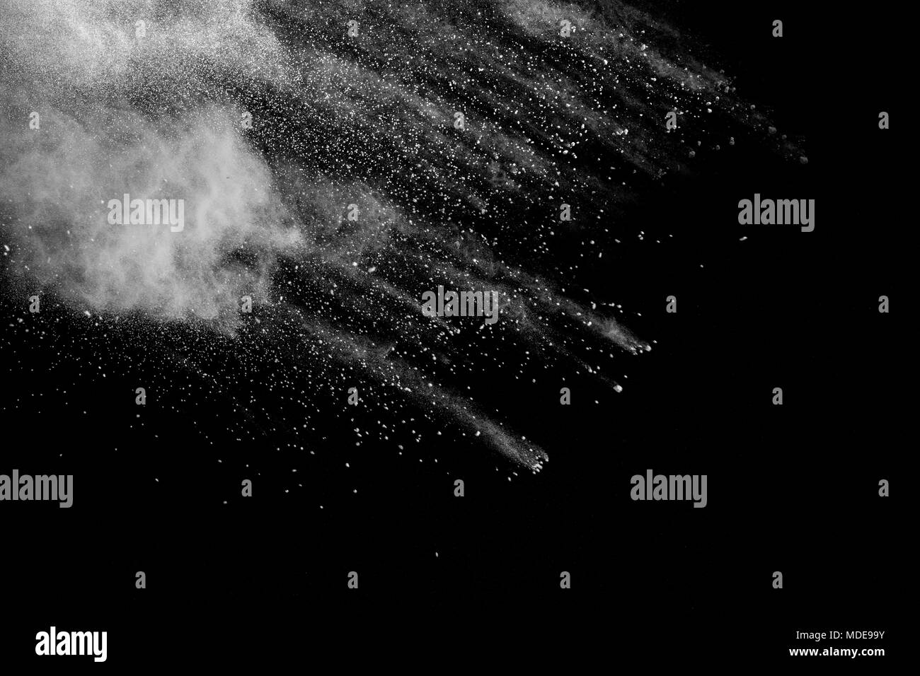 Bizarre forms of white powder explosion cloud against dark background ...