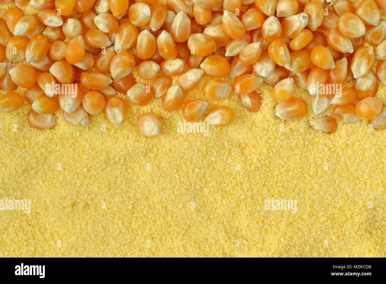 Dry corn kernels and corn flour background Stock Photo - Alamy