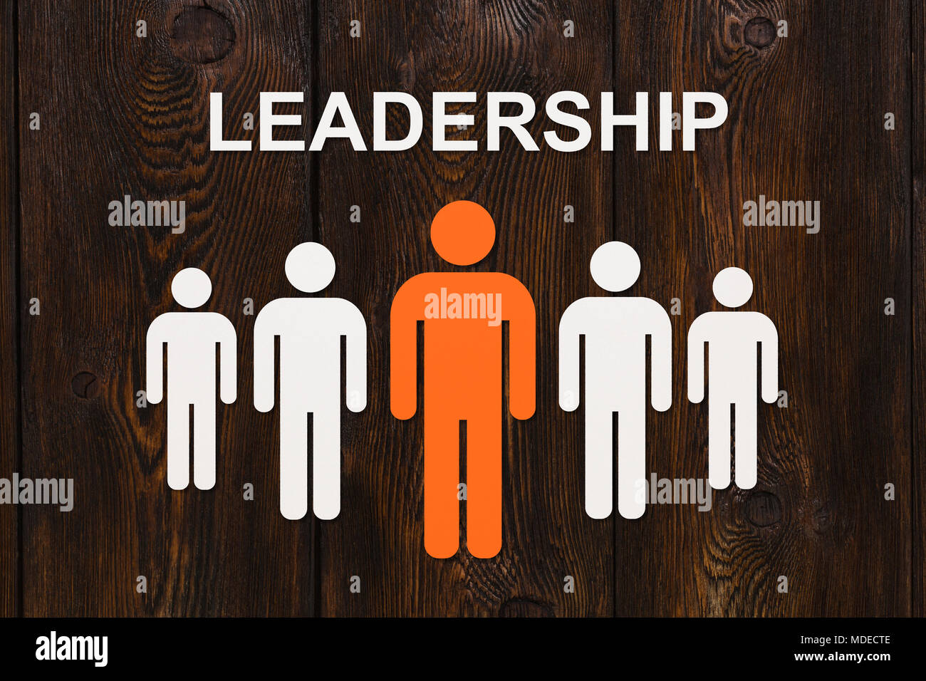 Leadership concept. Paper men on wooden background. Abstract business ...
