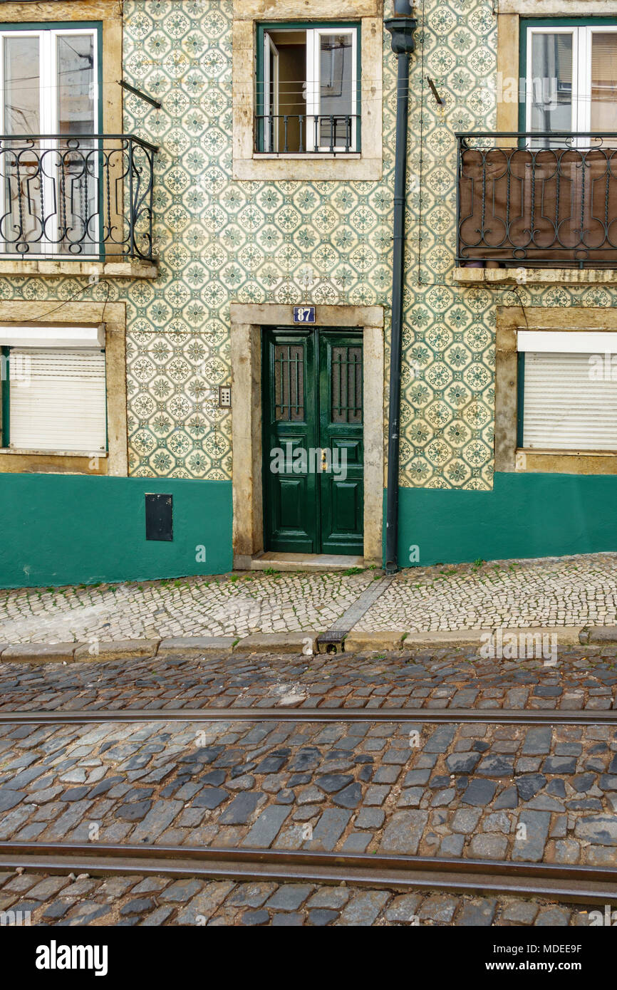Lisbon high slope street with rail and tile facade Stock Photo - Alamy
