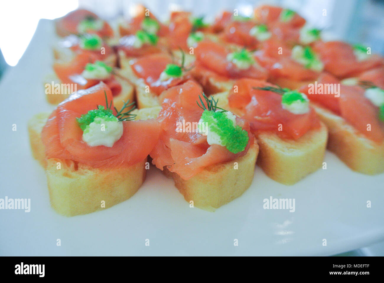 Nice appetizer, fusion food, smoked salmon on baguette with mayonnaise ...
