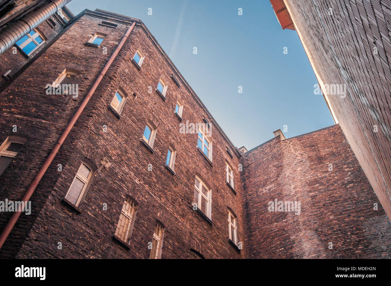 Courtyard of an old red brick tenements house in the center of Katowice ...