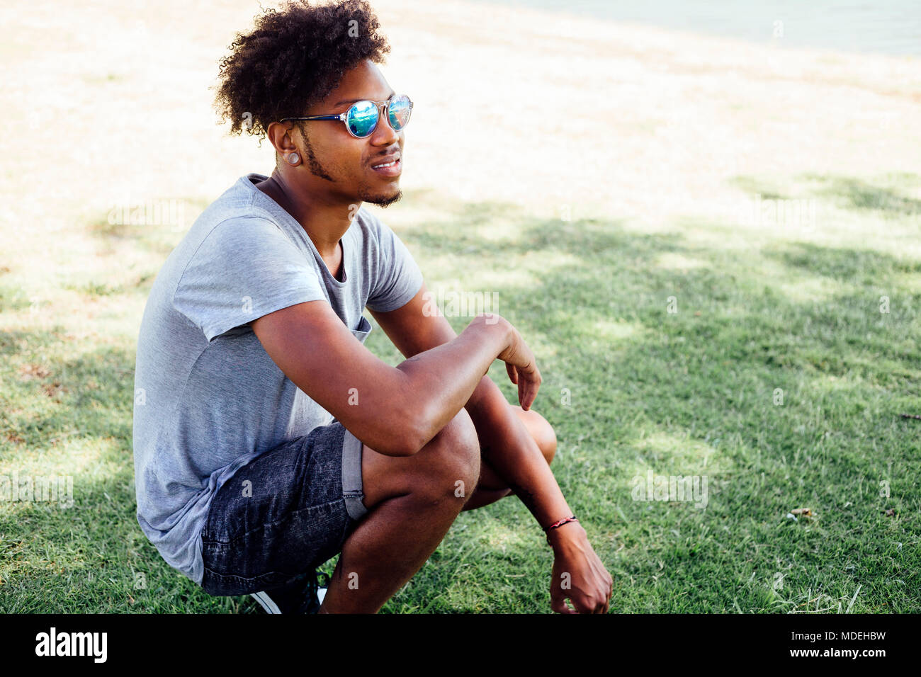 Male squatting hi-res stock photography and images - Alamy