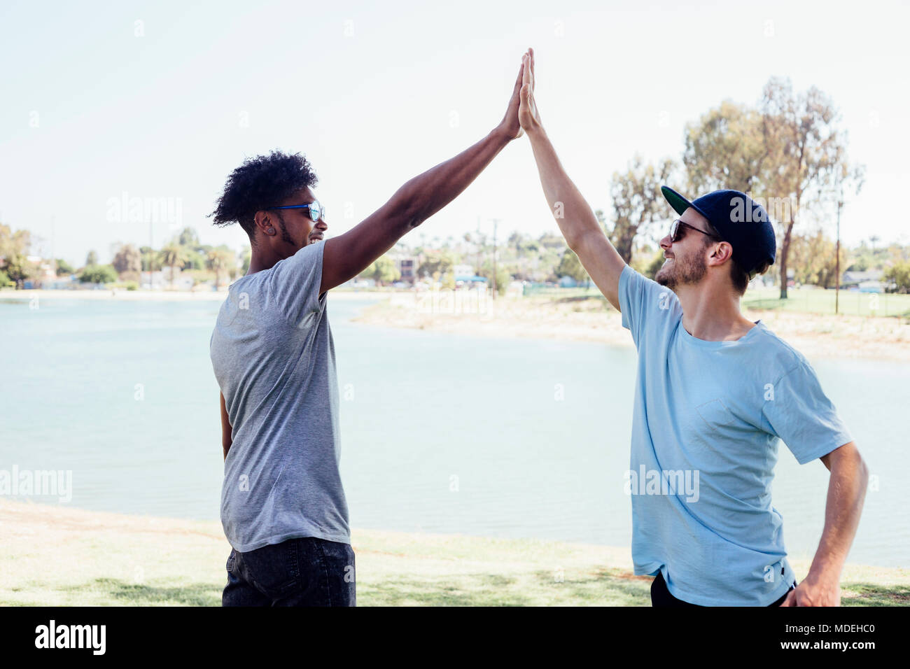 Five young people doing a high five hi-res stock photography and images ...