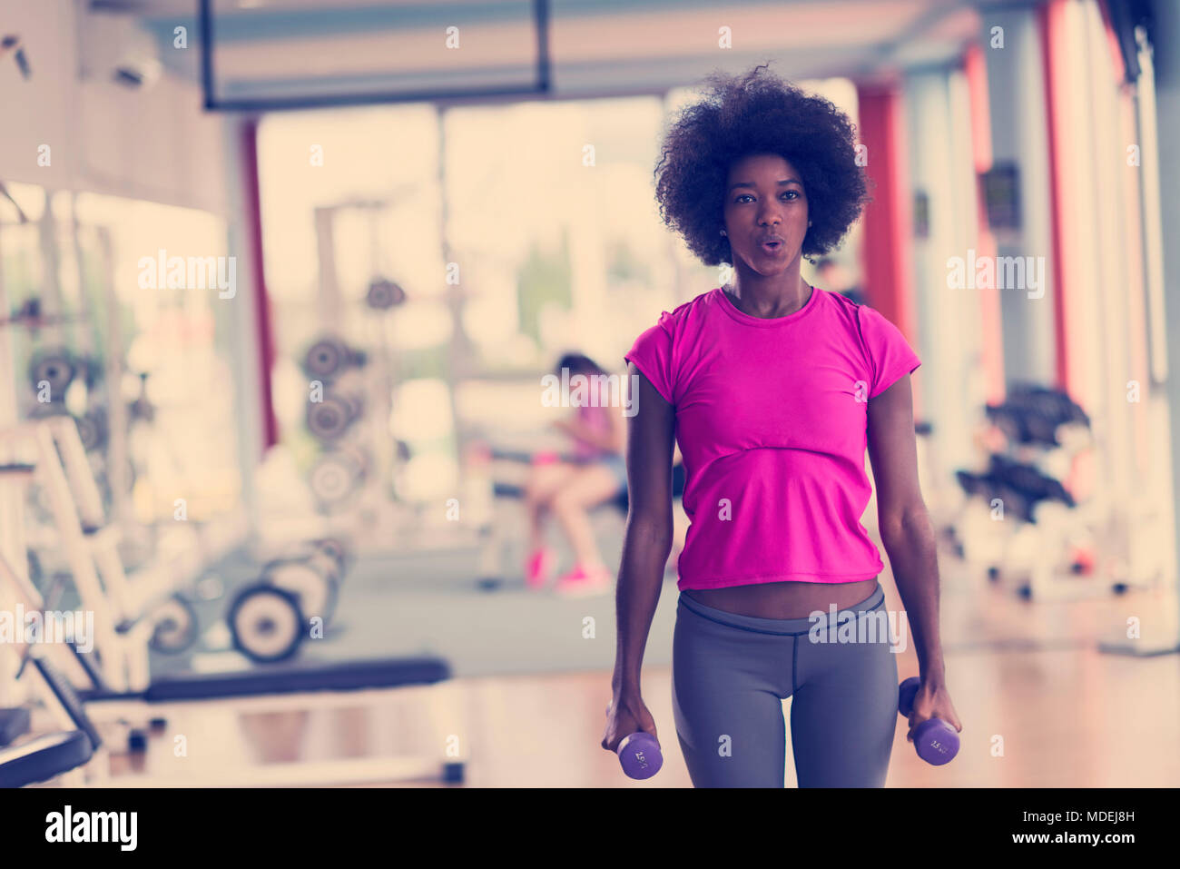 happy healthy african american woman working out in a crossfit gym on ...