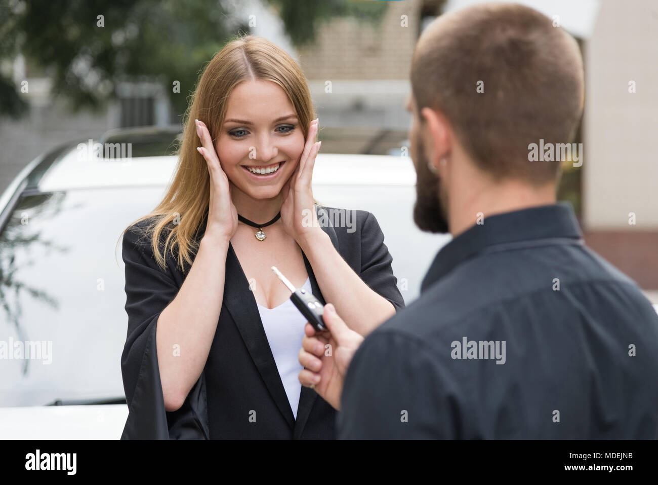 Happy girl gets car keys Stock Photo - Alamy