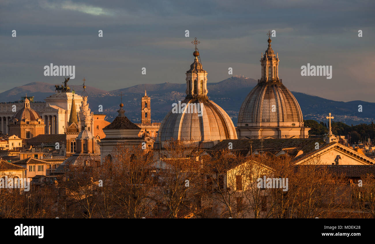 View of Rome historic center at sunset with baroque domes and ...