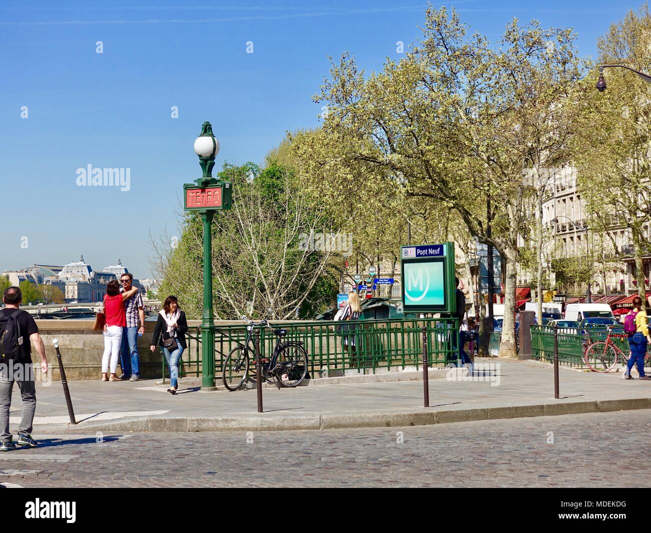 People passing by the entrance to the Line 7, Pont Neuf Métro, Paris ...