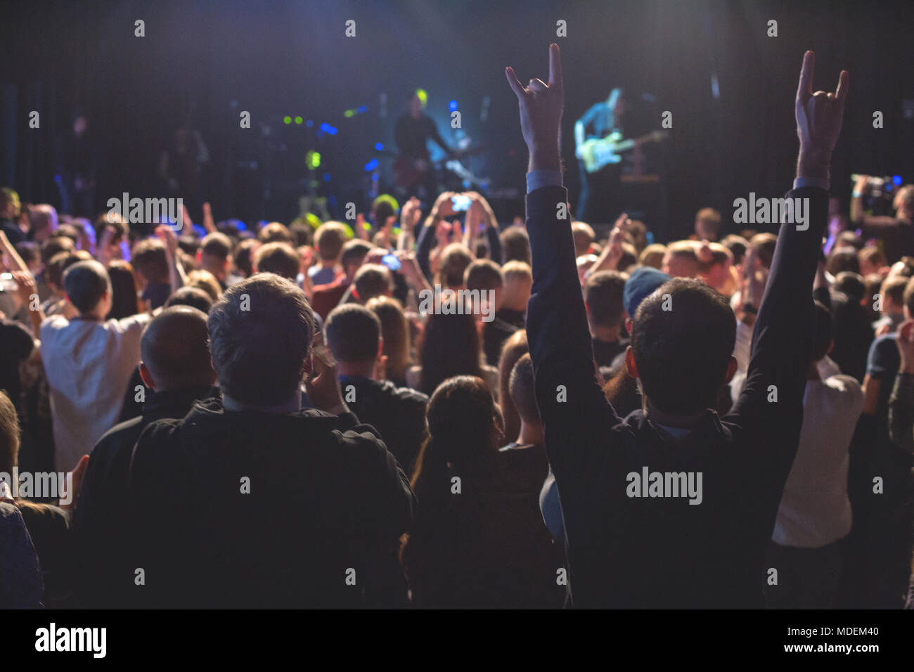 The audience watching the concert on stage in big concert club Stock ...