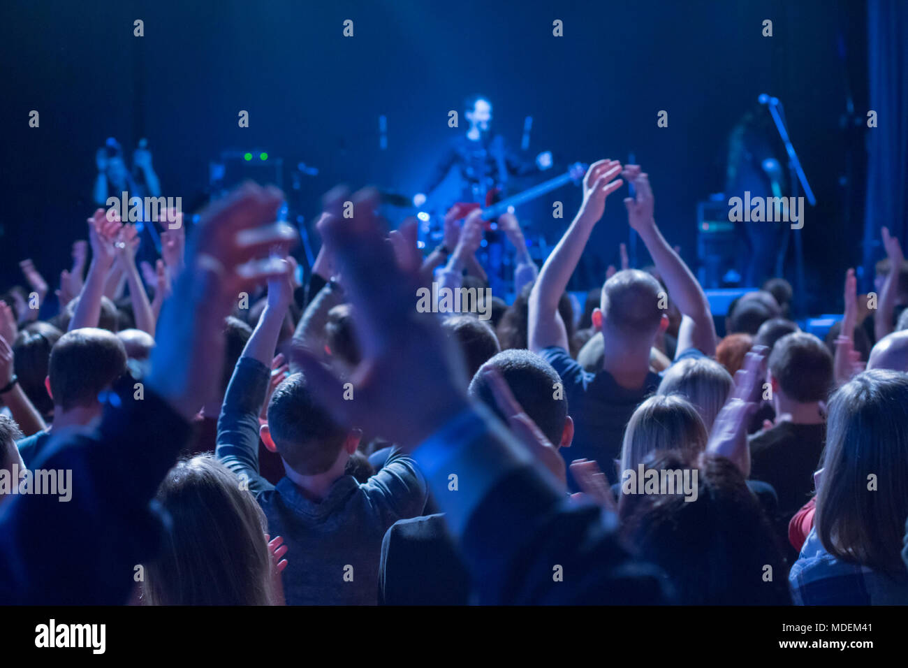 The audience watching the concert on stage in big concert club Stock ...