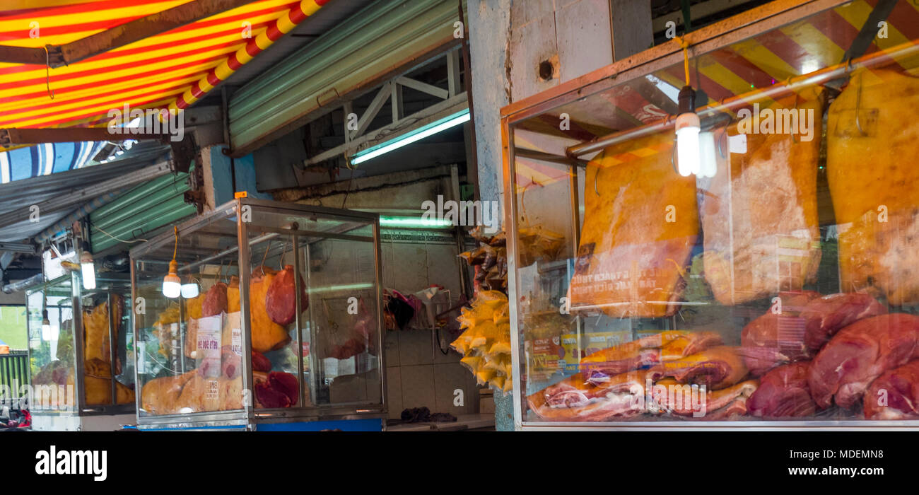 Slabs of meat on display in glass cabinets of butcher shops in Ho Chi ...
