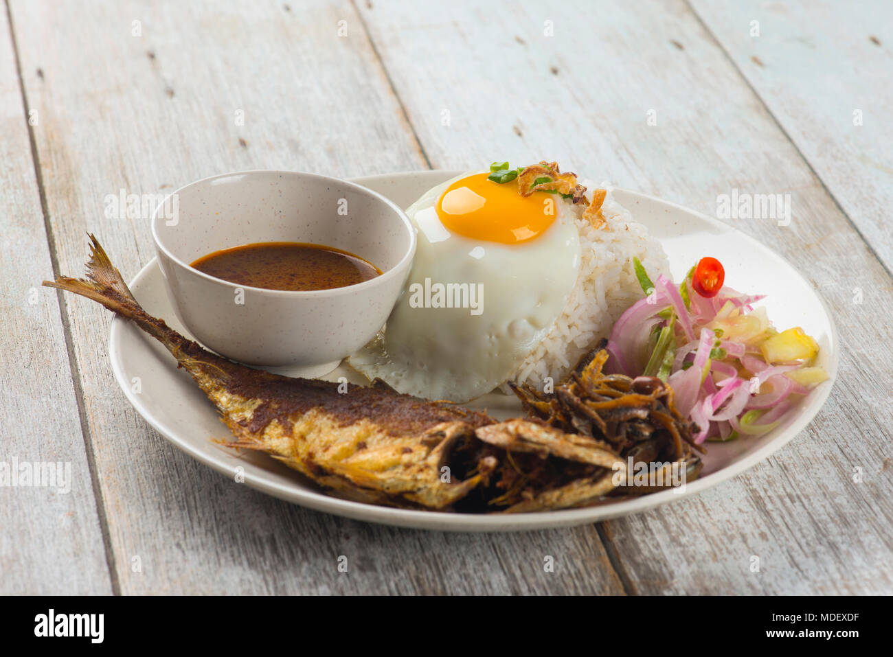 fried fish with rice with spices and curry Stock Photo - Alamy
