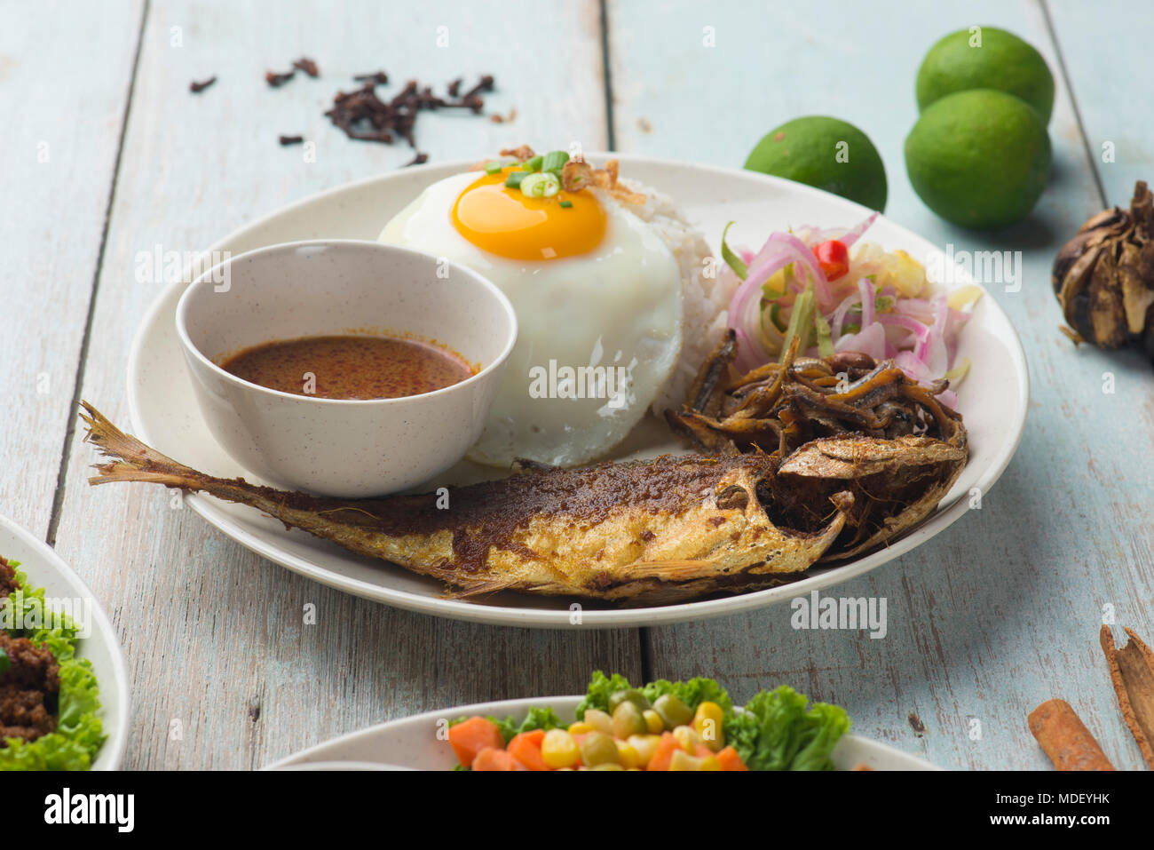 fried fish with rice with spices and curry Stock Photo - Alamy
