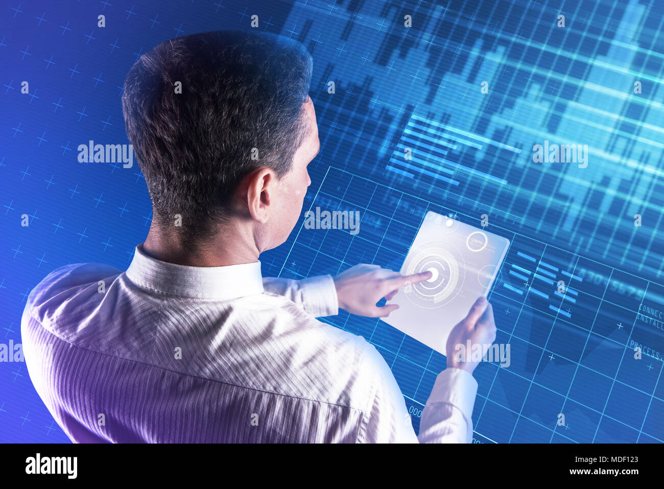 Calm project manager touching the screen of a tablet while working ...