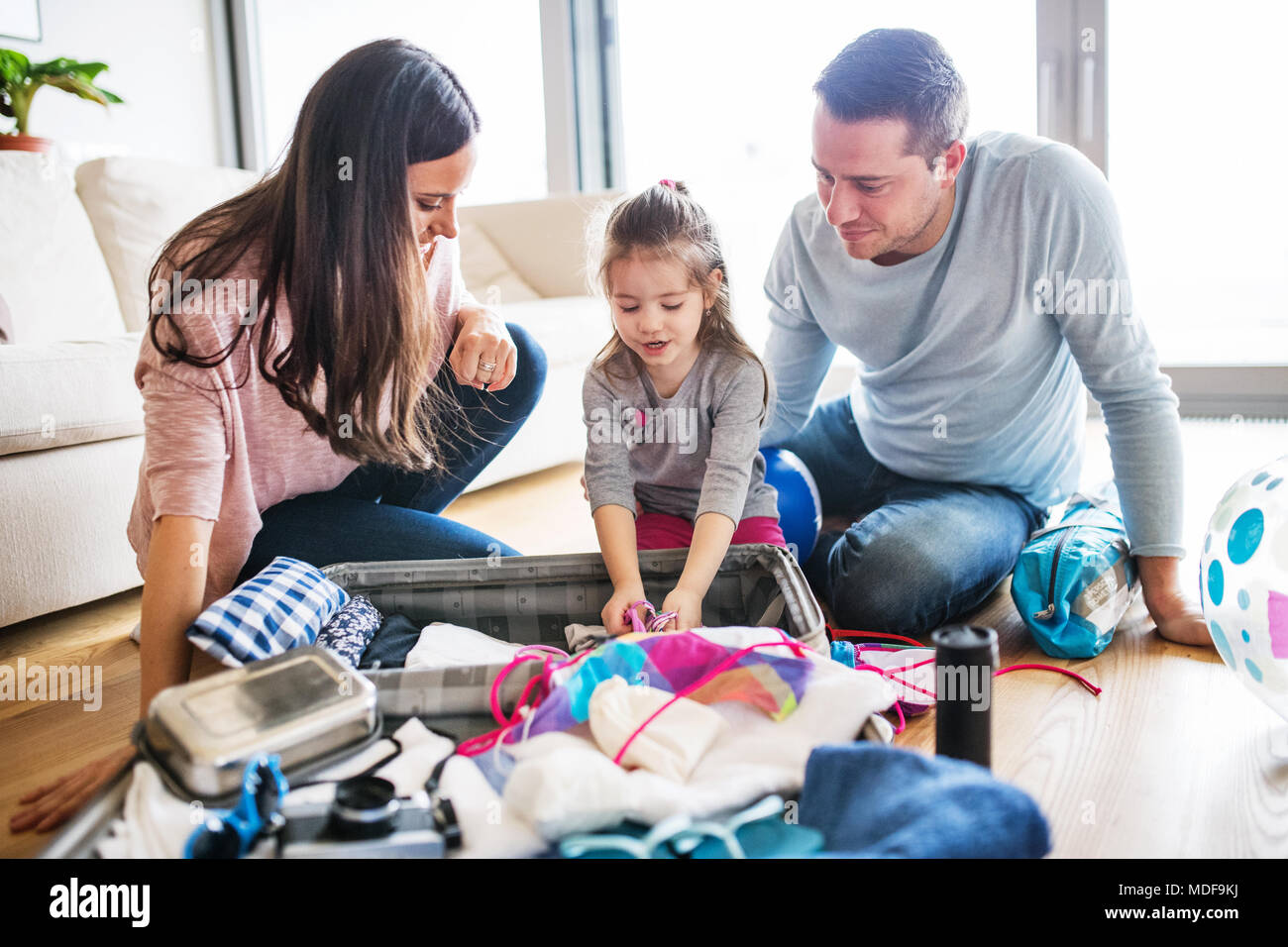 Young family with a child packing for holiday Stock Photo - Alamy