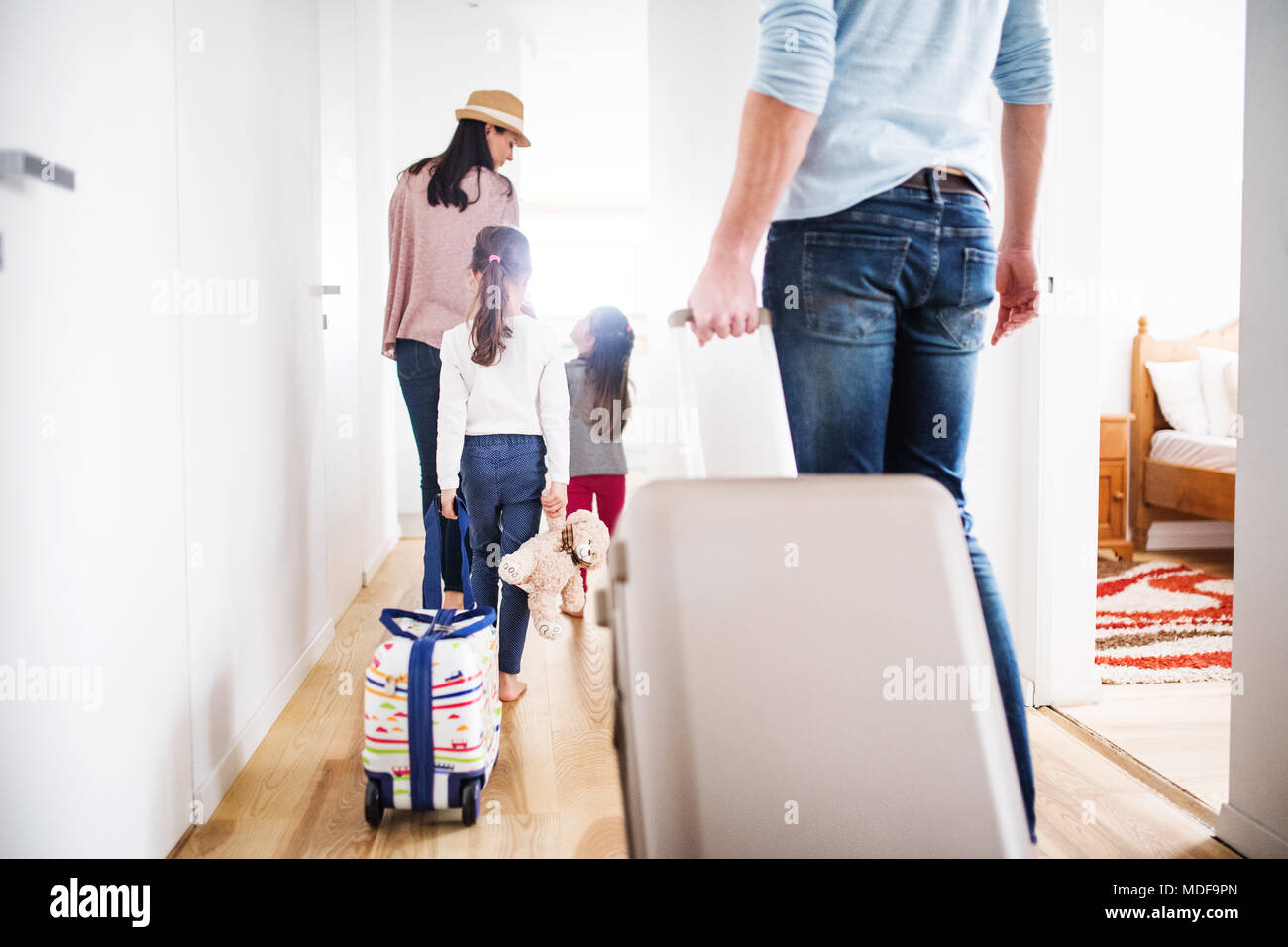 Young family with two children going on a holiday Stock Photo - Alamy