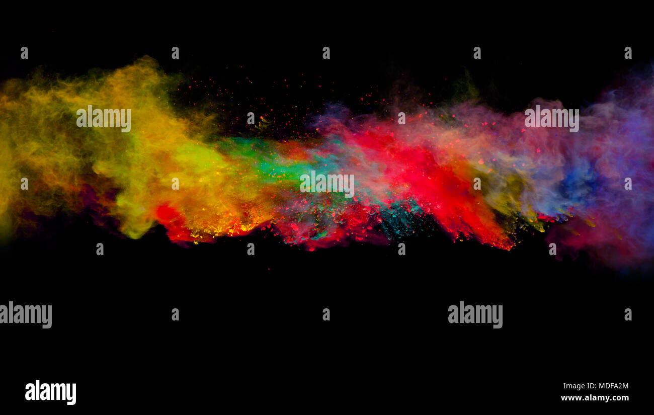 Abstract colored powder explosion isolated on black background. High ...