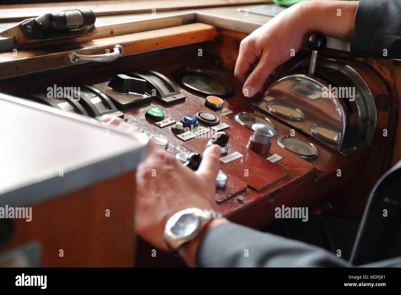 The train driver at the engine controls of the Drachenfelsbahn, an ...