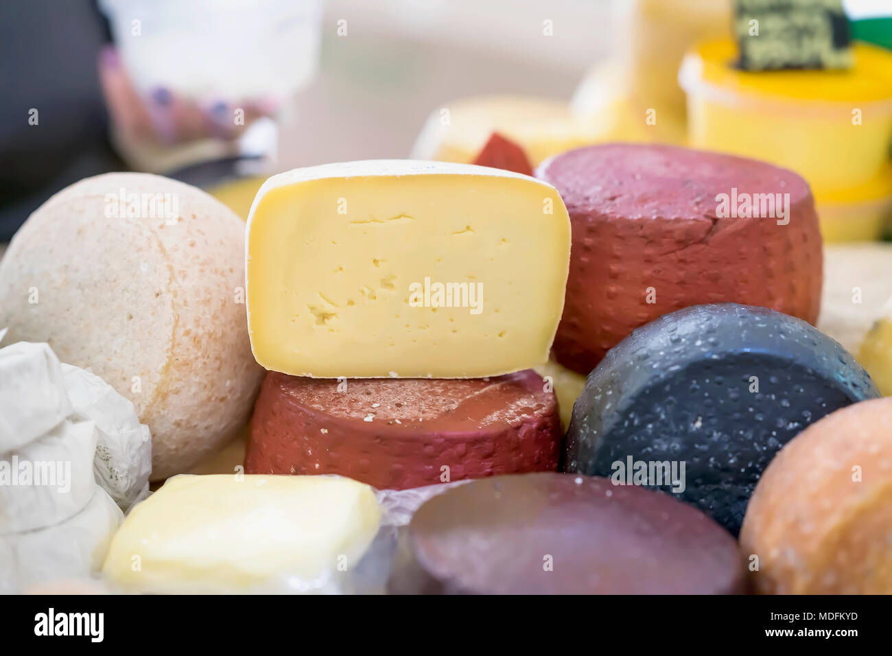 Cheese wheels different grades and cut pieces on market counter ...
