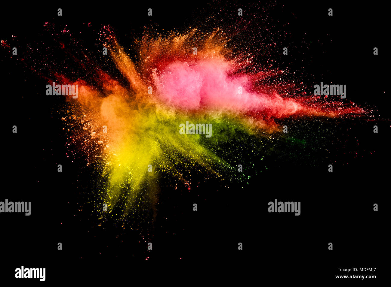 Multi color powder explosion isolated on black background. Colored dust ...